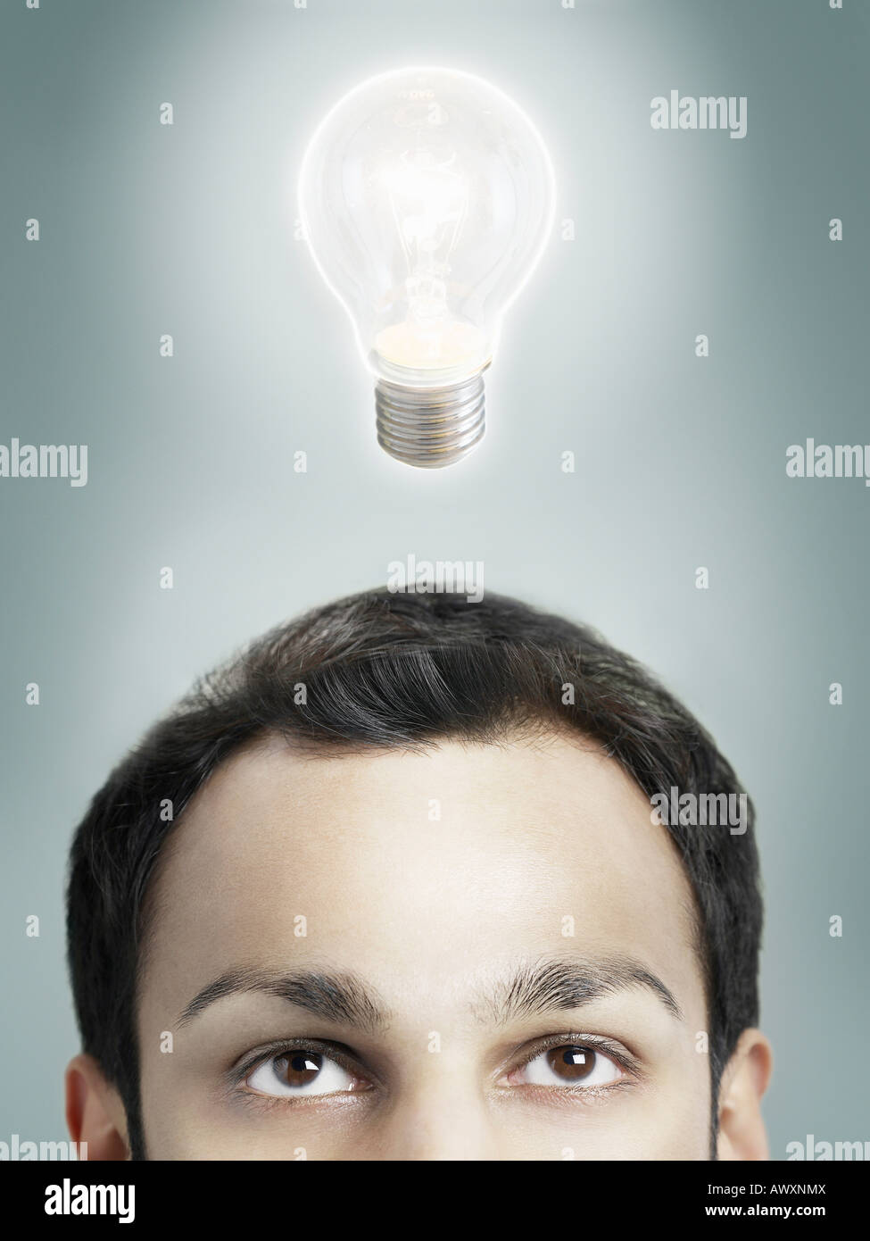 Illuminated lightbulb over man's head, high section, studio shot Stock ...