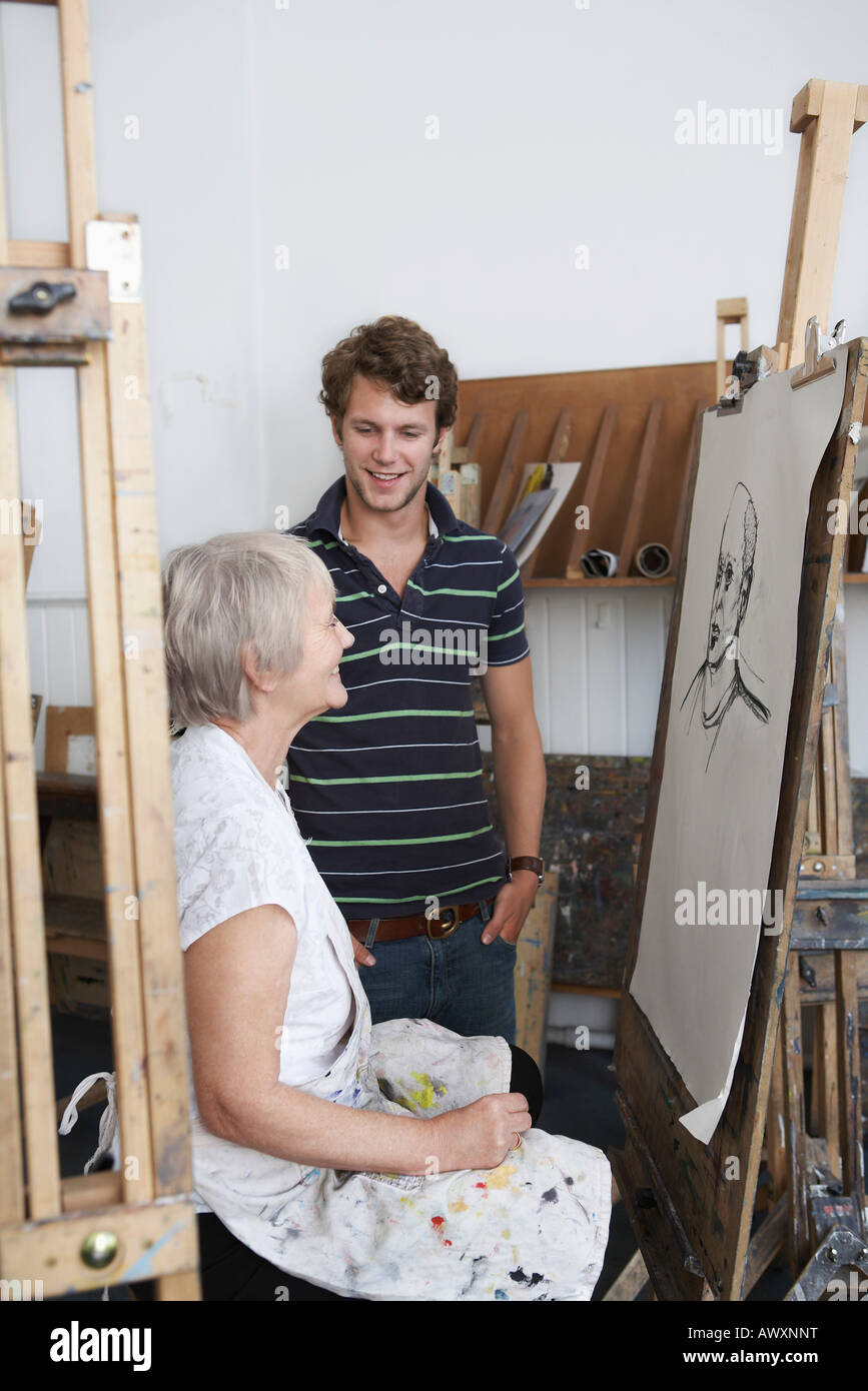 Artist drawing portrait in studio, young man looking on Stock Photo - Alamy