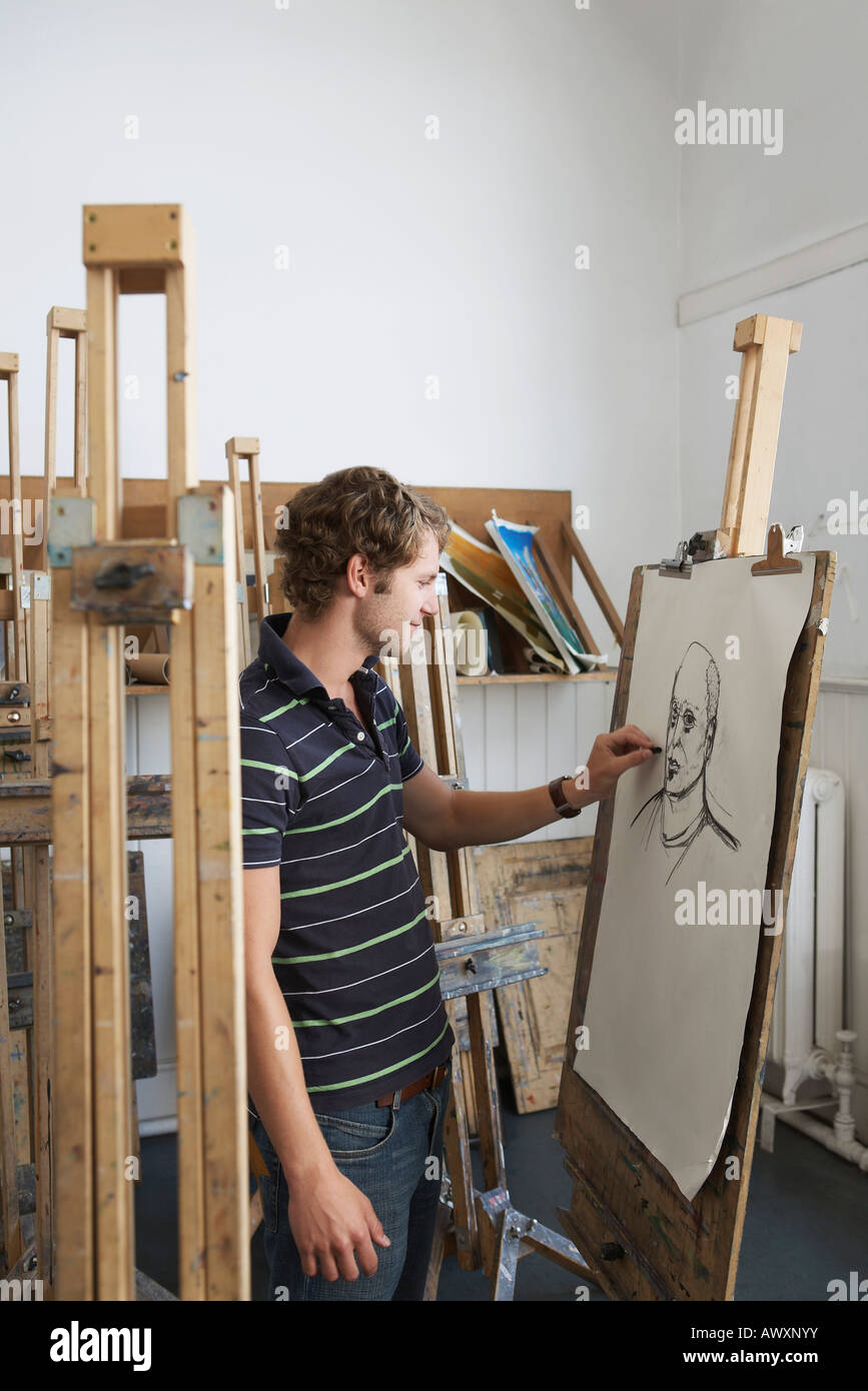 Artist drawing charcoal portrait in studio, side view Stock Photo - Alamy