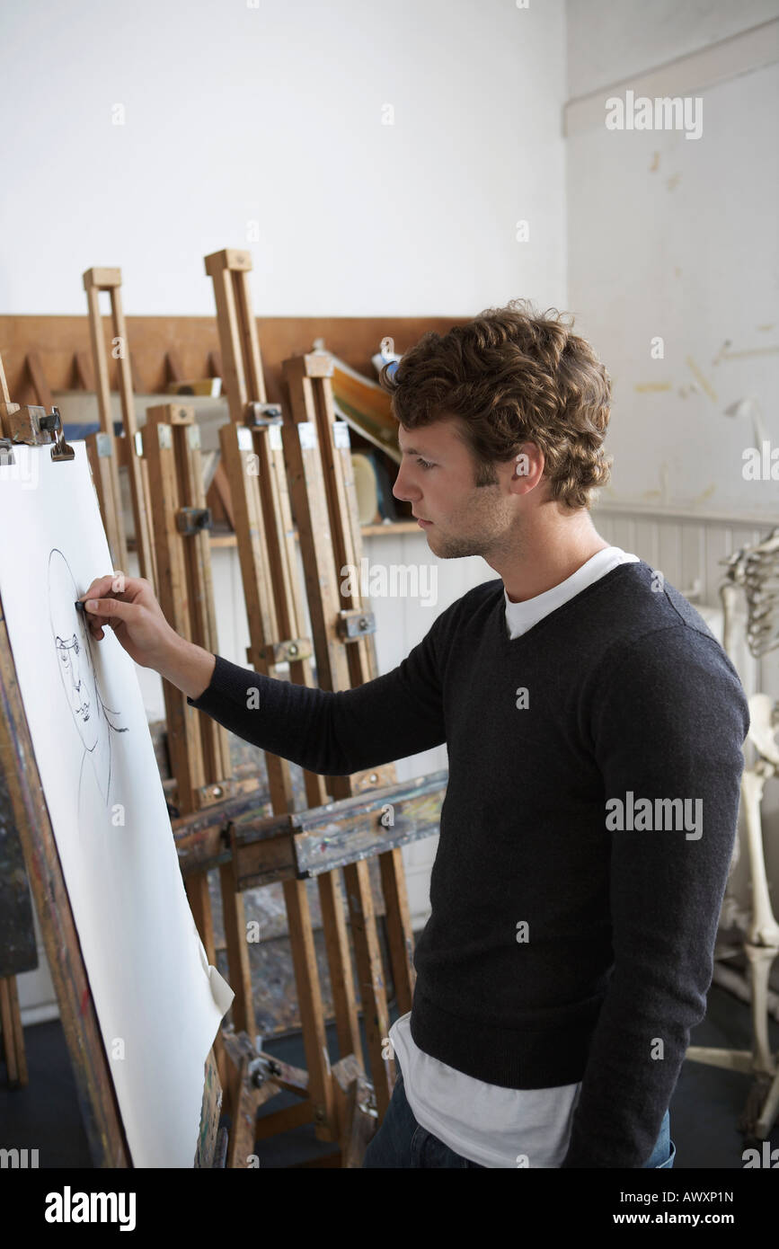 Artist drawing charcoal portrait in studio, side view Stock Photo - Alamy
