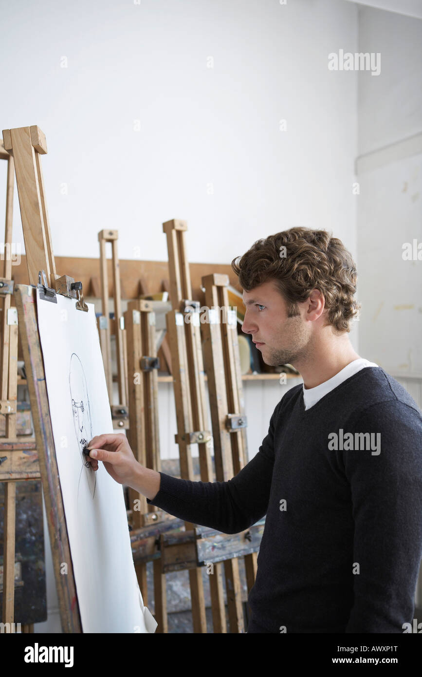 Artist drawing charcoal portrait in studio, side view Stock Photo - Alamy