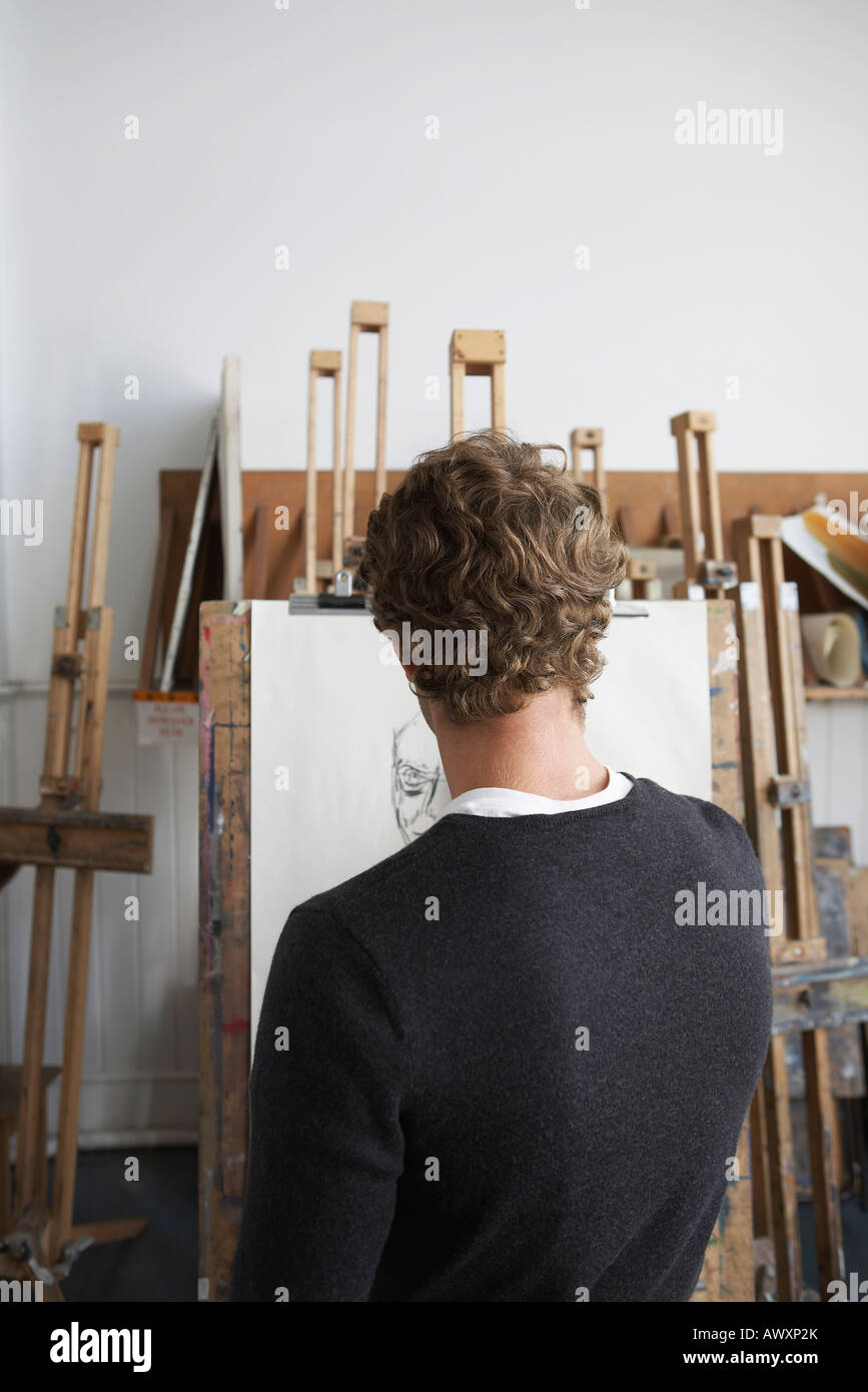 Artist drawing charcoal portrait in studio, back view Stock Photo - Alamy