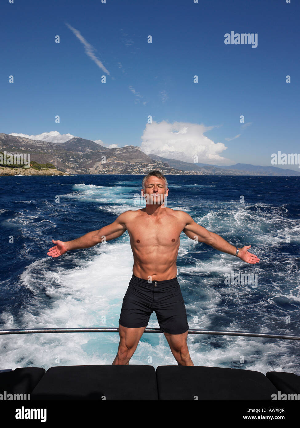 Man with Arms Outstretched on Boat Stock Photo - Alamy