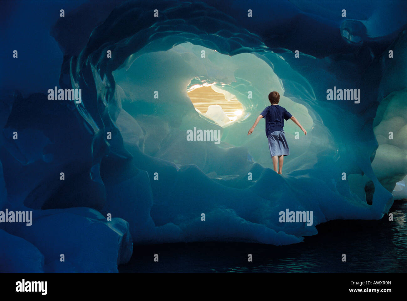 Boy Standing on Iceberg Stock Photo - Alamy