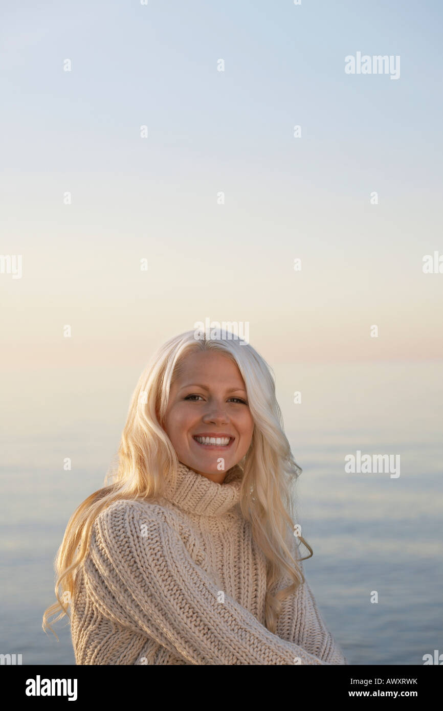 Young woman smiling on beach, portrait Stock Photo - Alamy