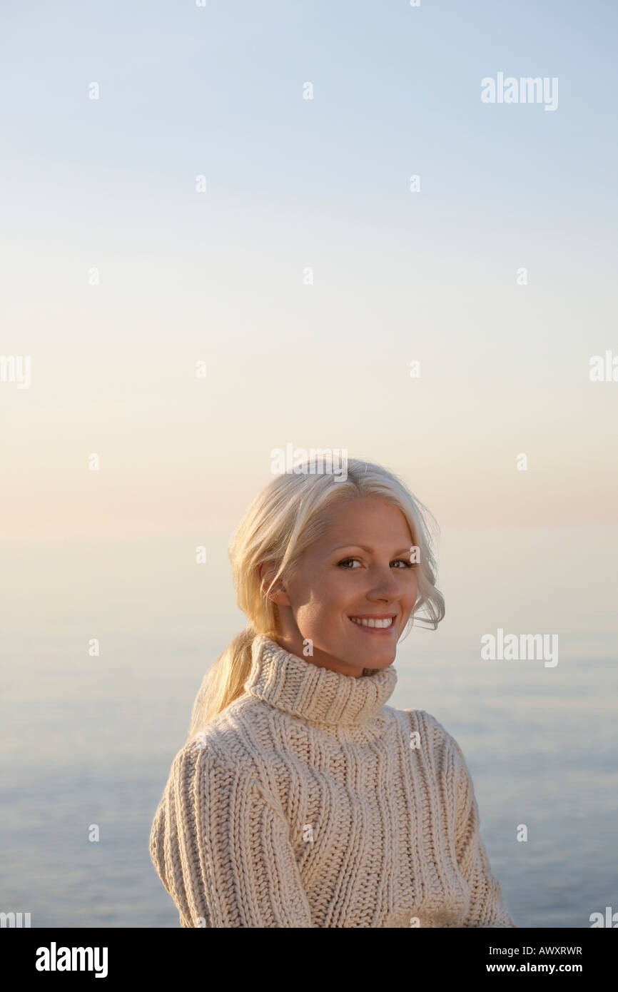 Young woman smiling on beach, portrait Stock Photo - Alamy