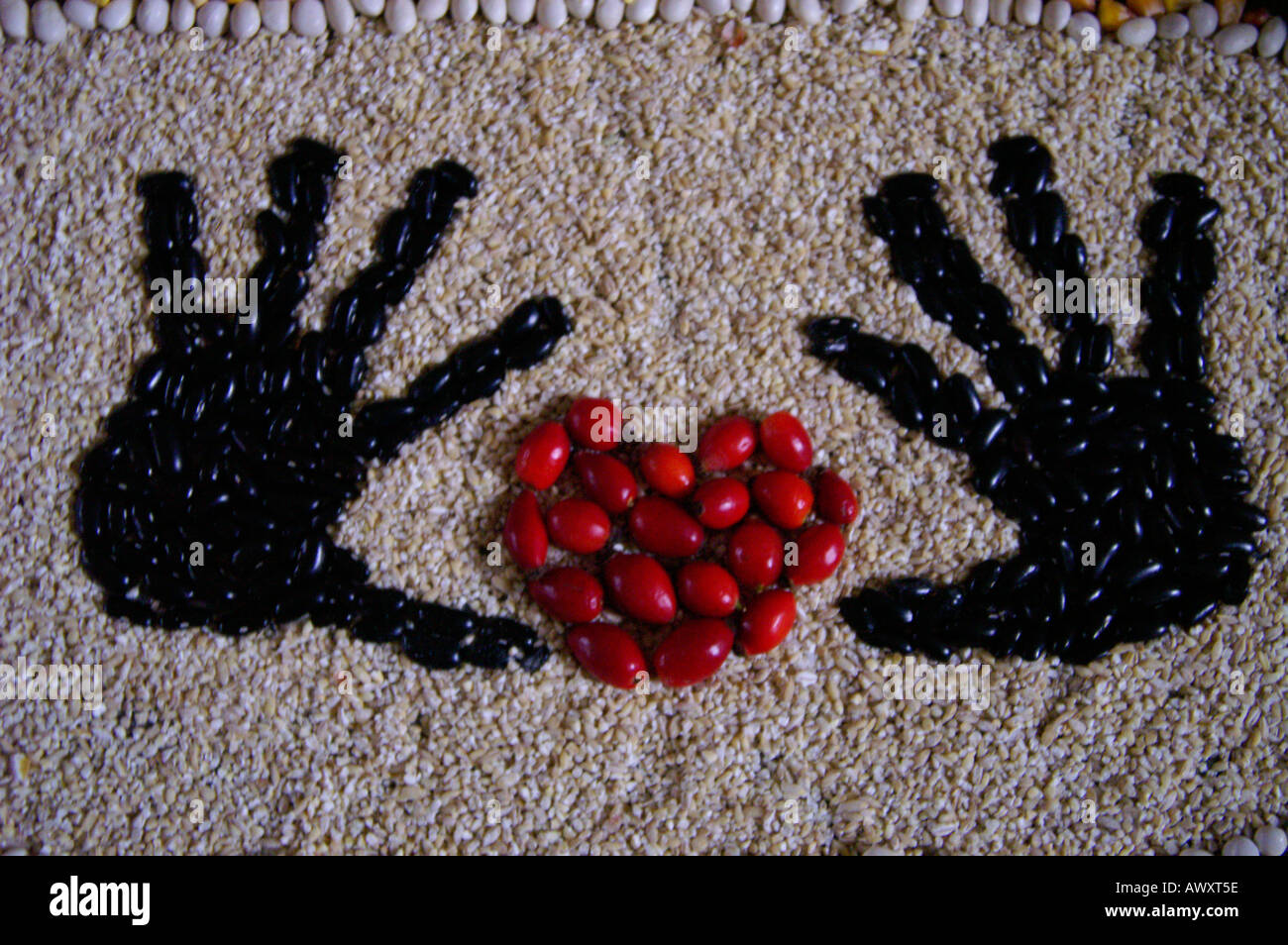 Black hands and Red heart made of beans in white sand Stock Photo - Alamy
