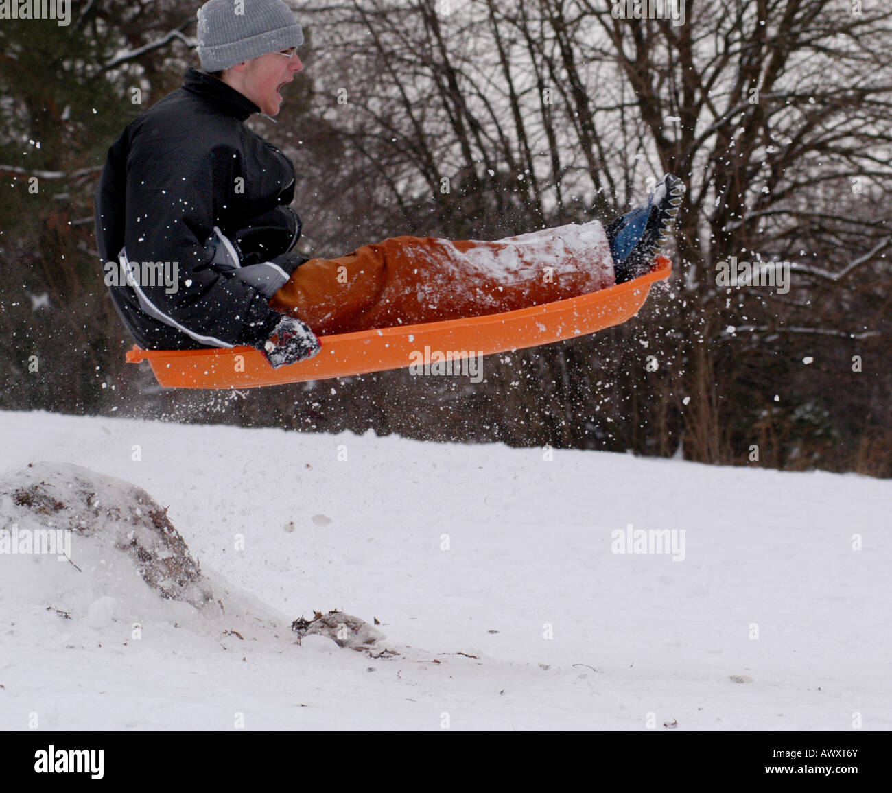 teens sledding sled riding Stock Photo - Alamy