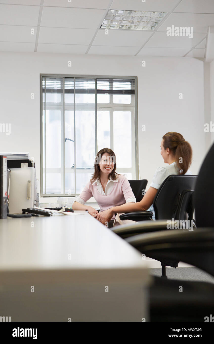 Two women talking in office Stock Photo - Alamy
