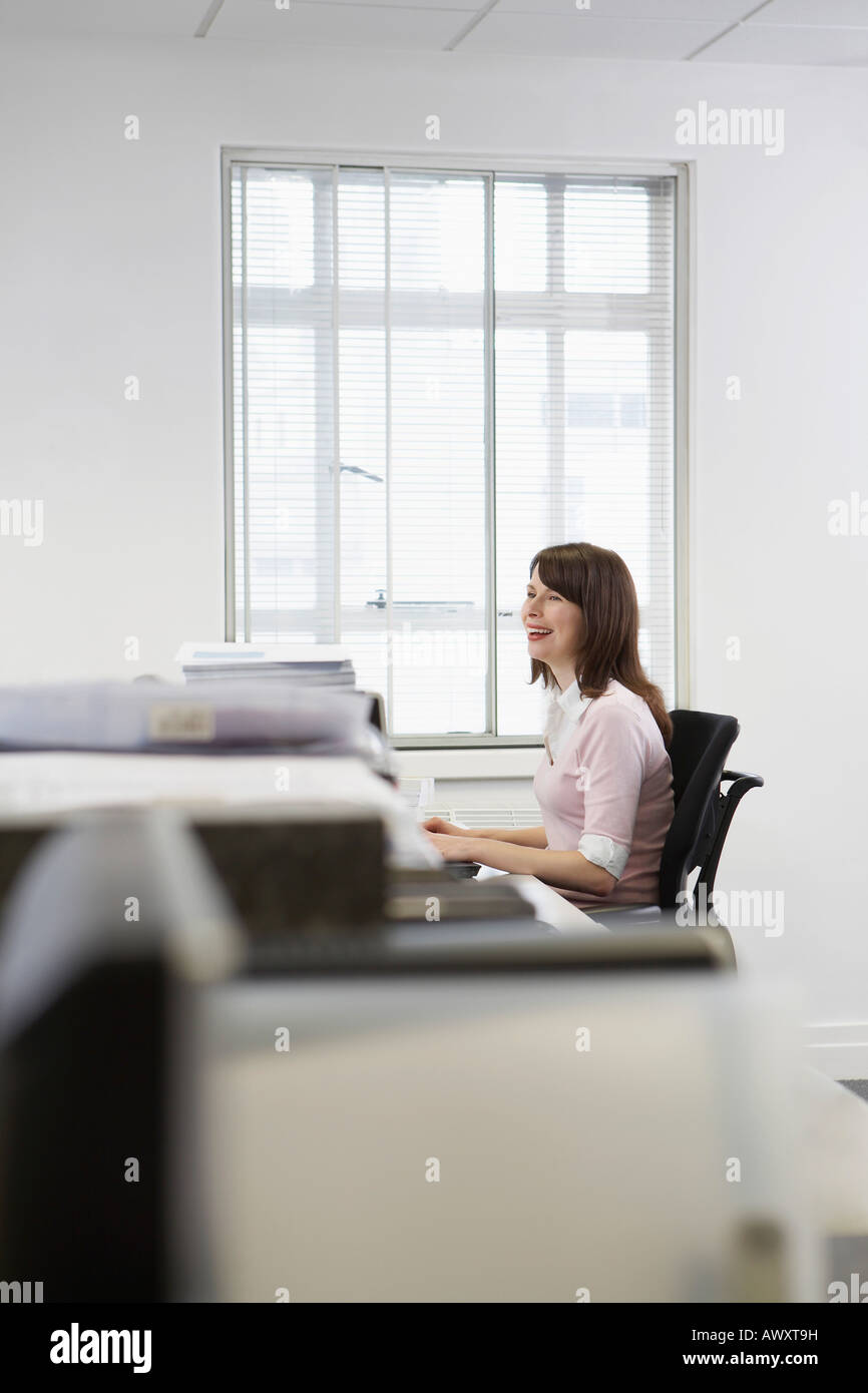 Woman working in office, side view Stock Photo - Alamy