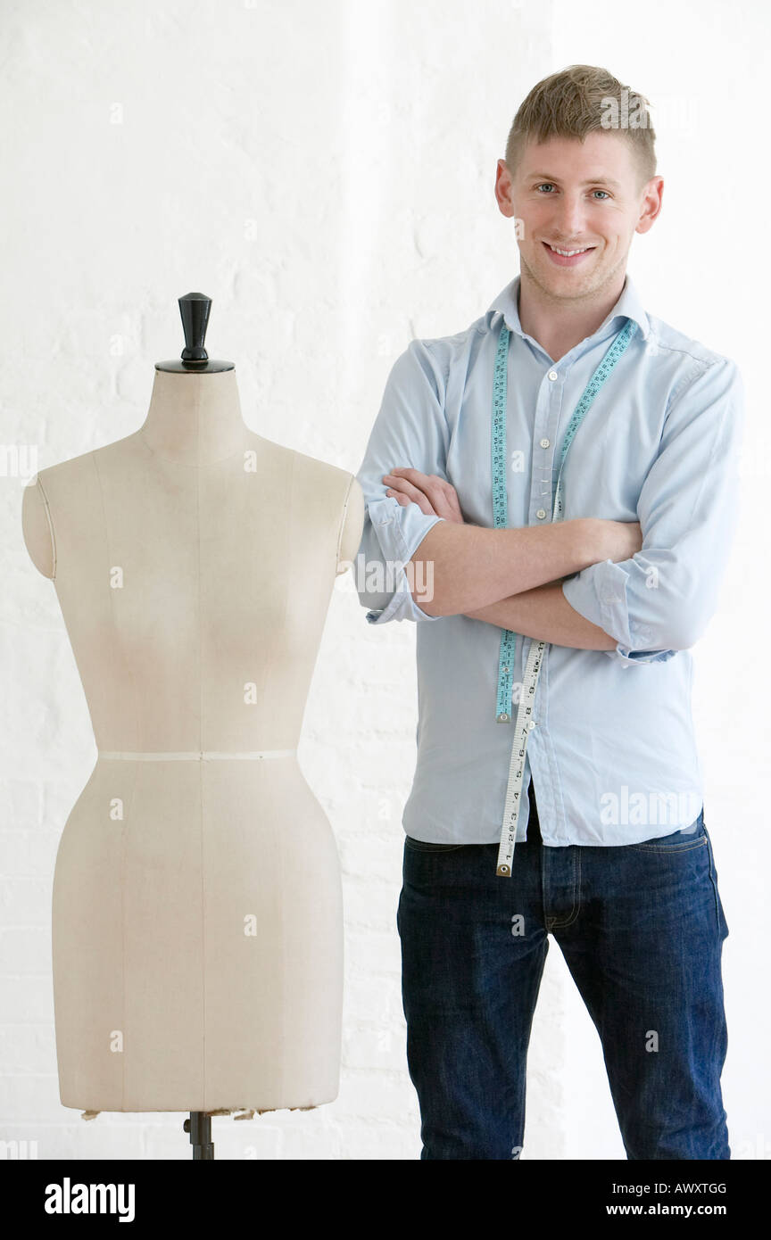 Tailor standing next to mannequin, portrait Stock Photo - Alamy