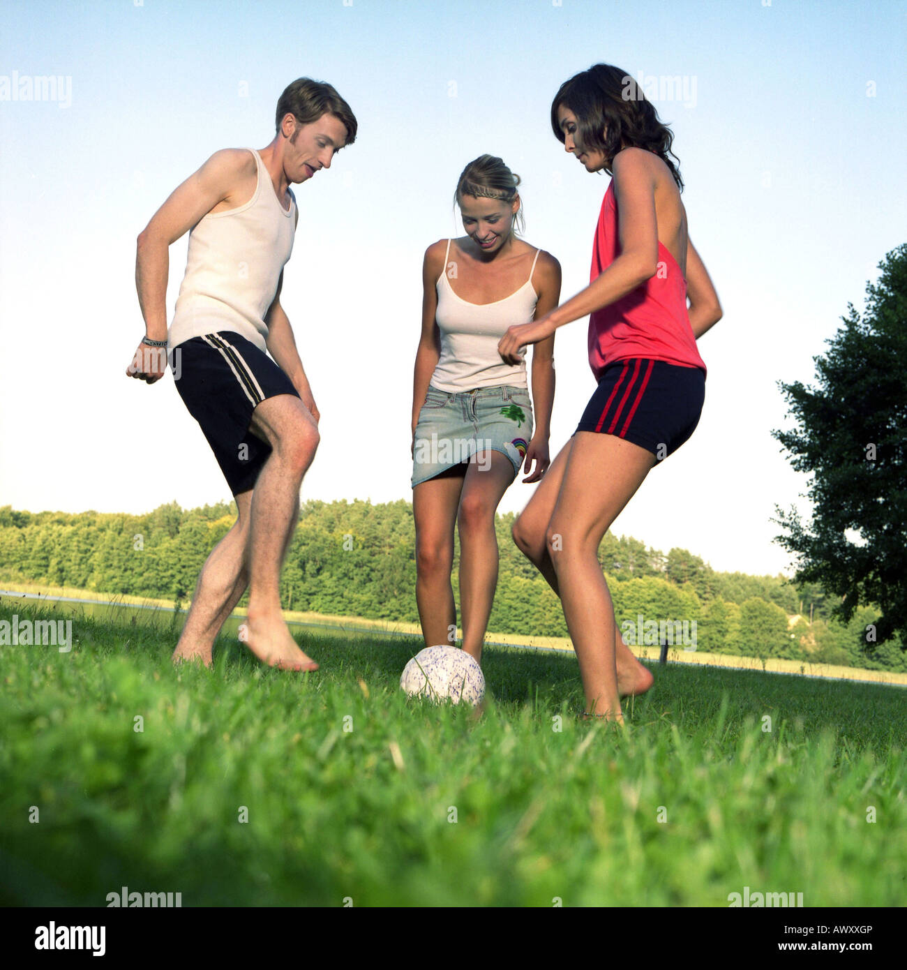 Young people playing football Stock Photo - Alamy