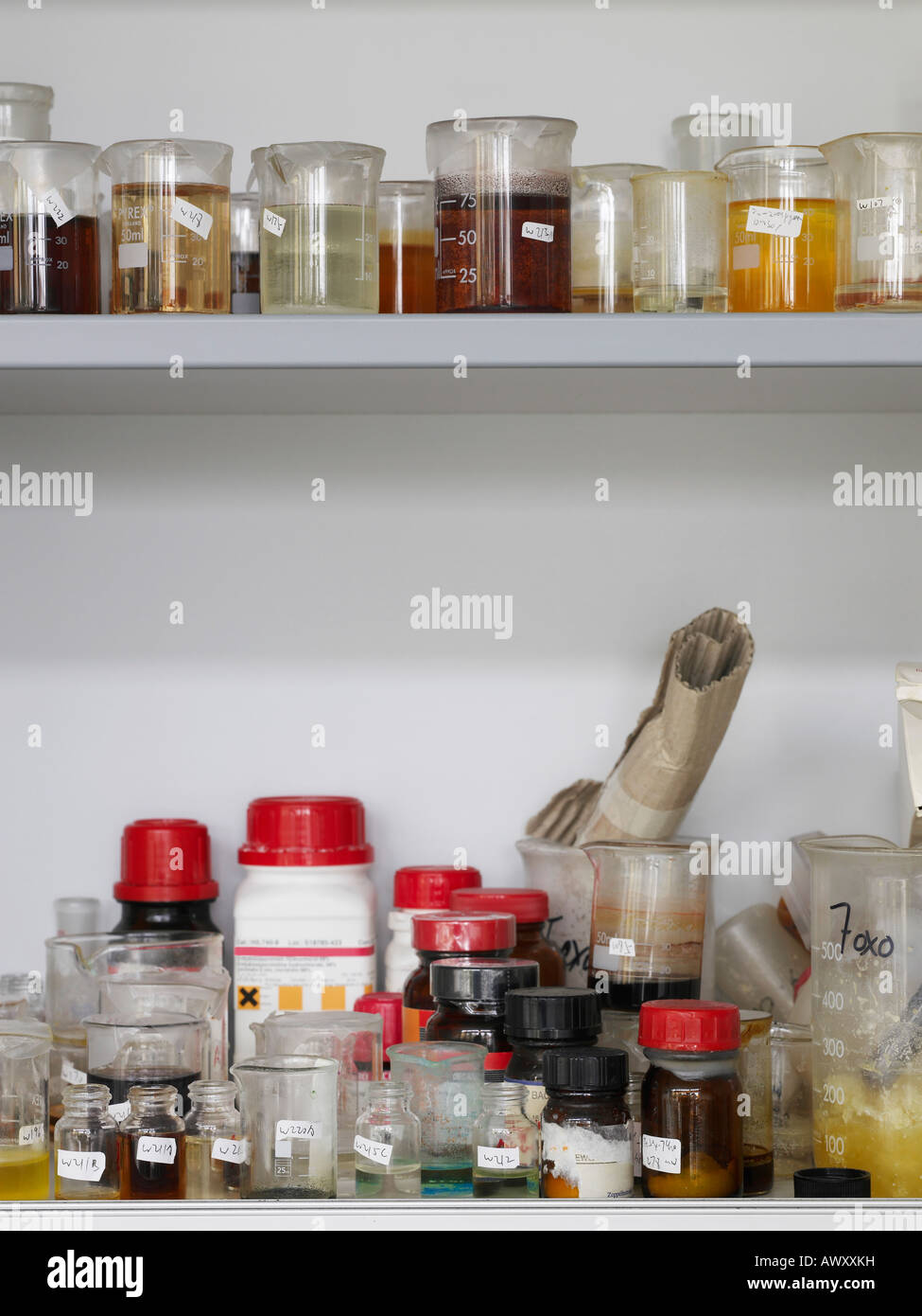 Bottles and lab flasks on shelves Stock Photo - Alamy