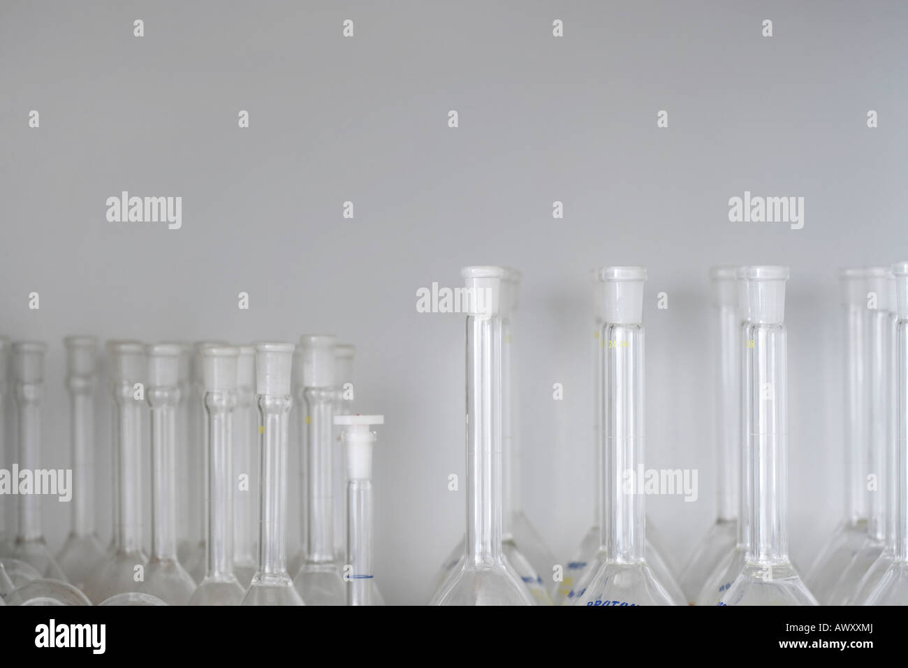 Laboratory flasks on shelf Stock Photo - Alamy