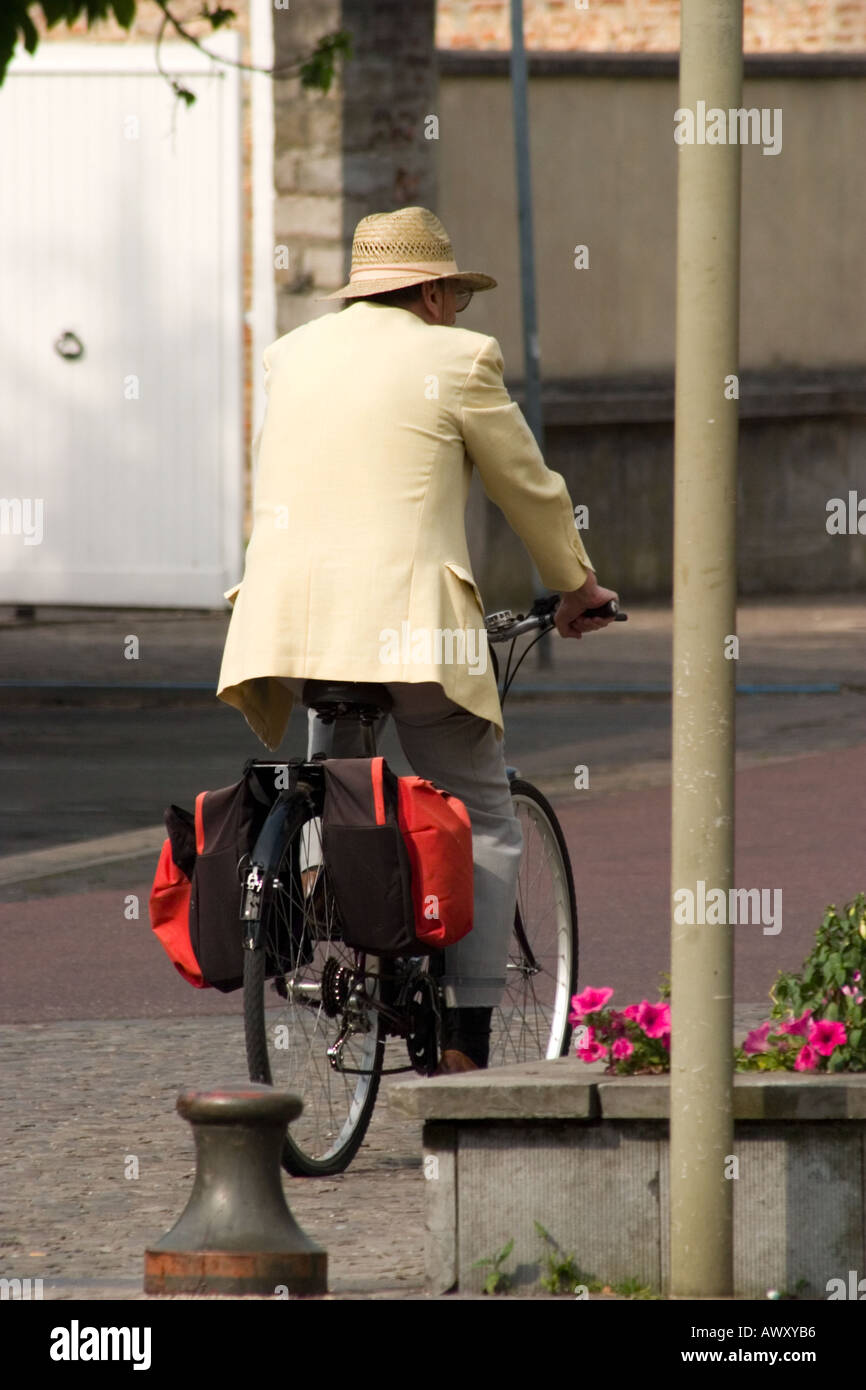 Elegant mature gentleman on bicycle wear pastel yellow blazer and straw ...