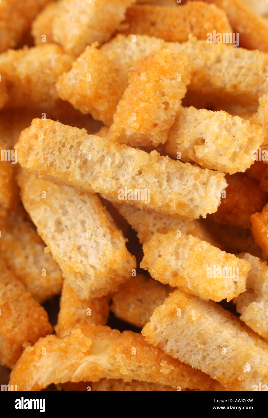 Yellow crouton fried bread slice closeup background Stock Photo - Alamy