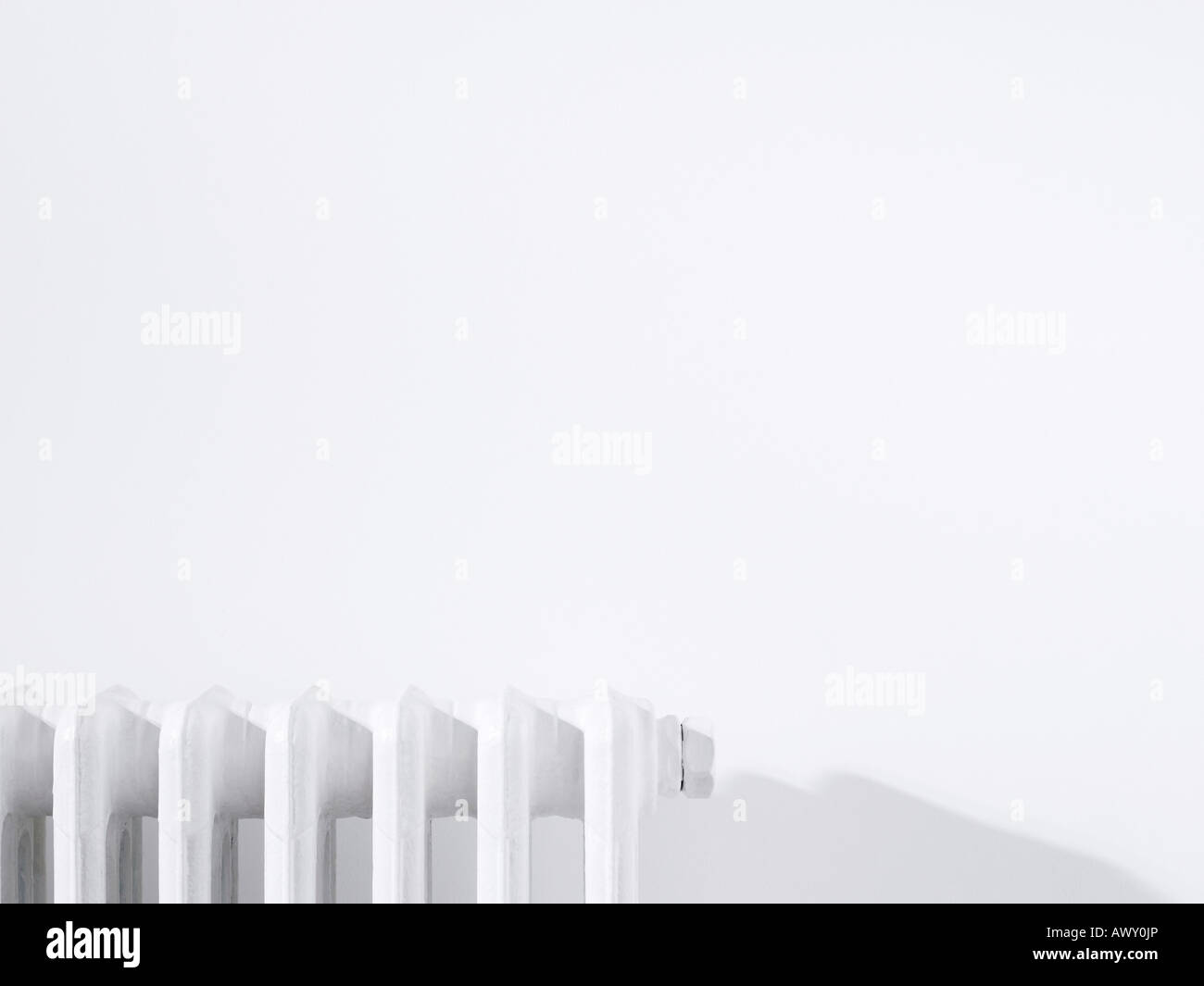 Radiator against white wall Stock Photo - Alamy