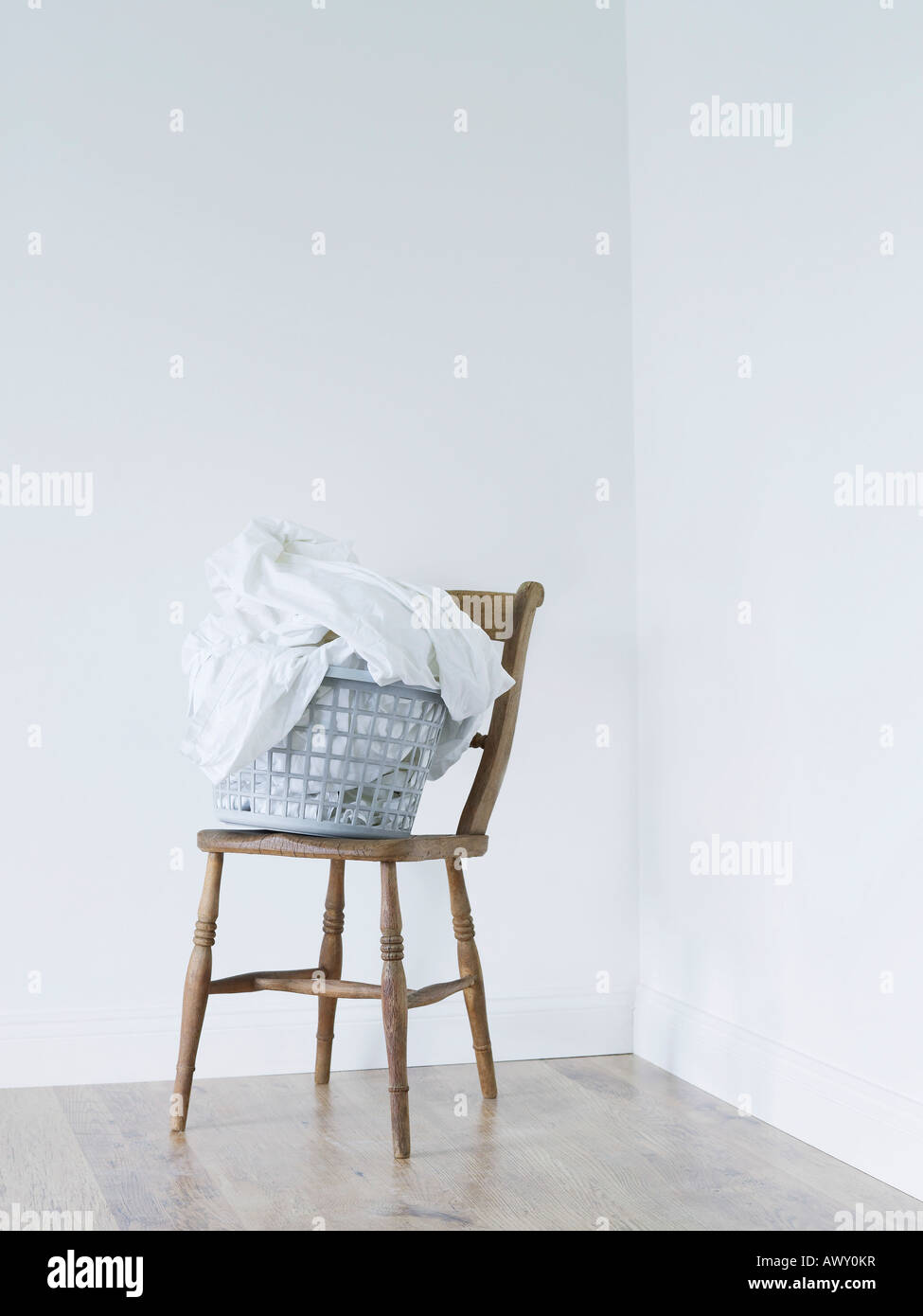 Laundry basket on chair in room Stock Photo - Alamy