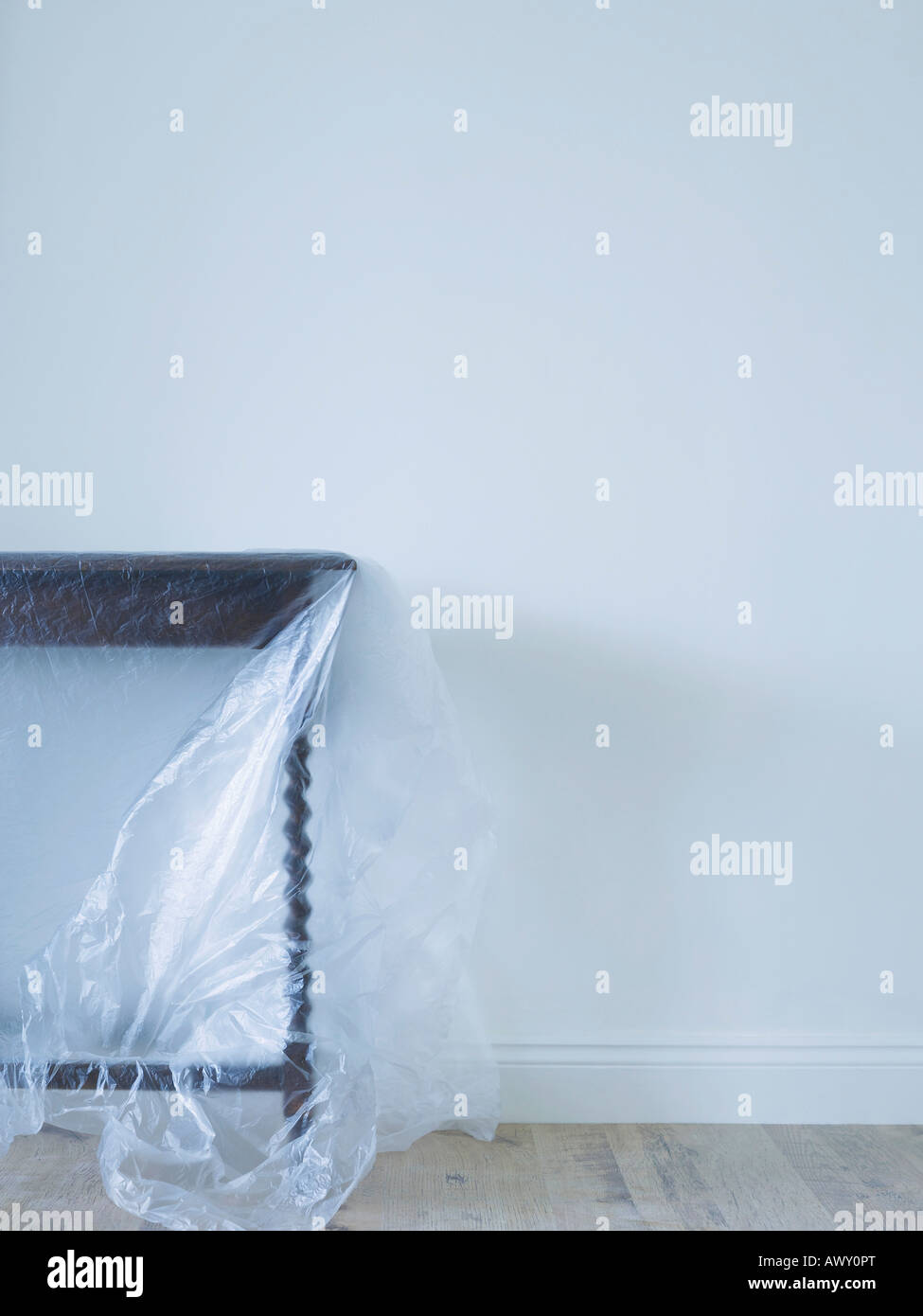 Table covered with plastic in empty room Stock Photo - Alamy