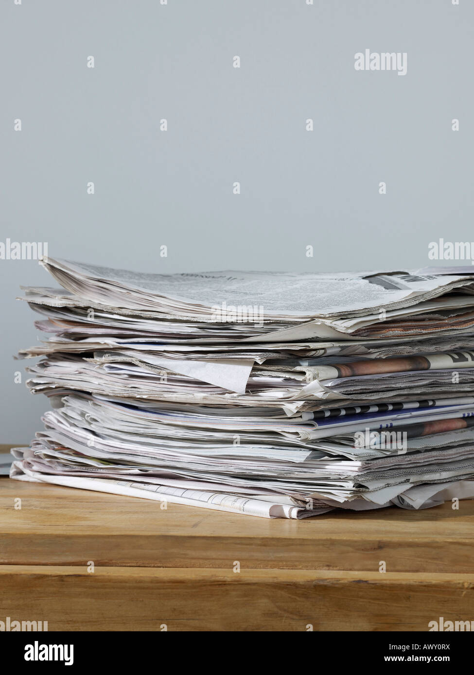 Stack of newspapers on table Stock Photo - Alamy