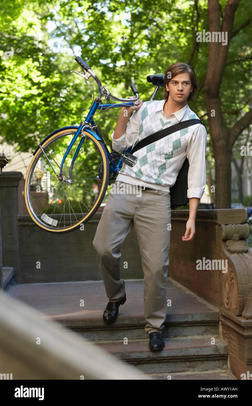 Man carrying bicycle, descending steps Stock Photo - Alamy