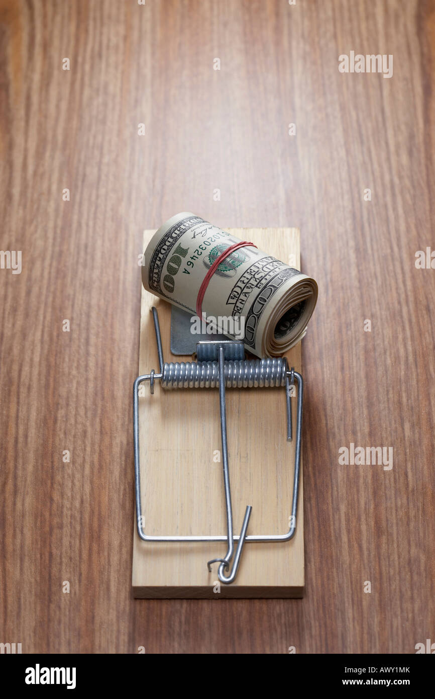 Roll of dollar bills in mouse trap Stock Photo - Alamy
