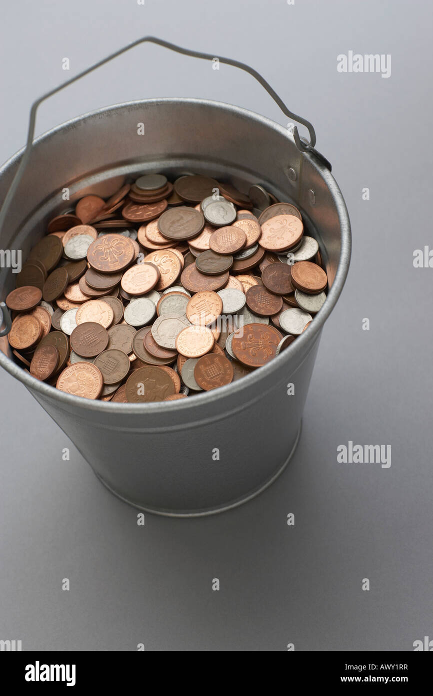 Bucket of coins Stock Photo - Alamy