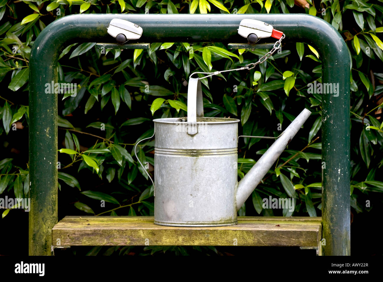 Locked watering can Stock Photo - Alamy