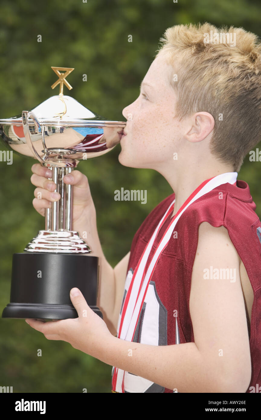 Boy holding and kissing a trophy Stock Photo - Alamy