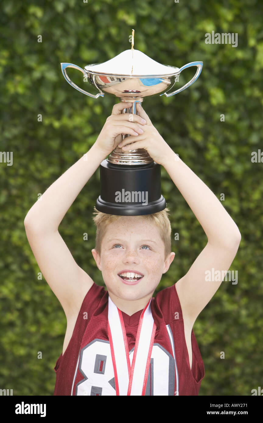 Boy balancing a trophy on his head Stock Photo - Alamy
