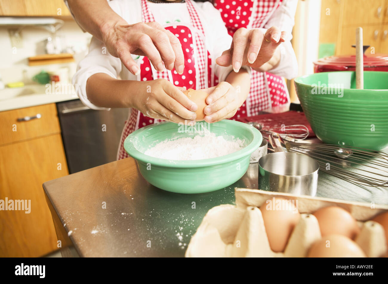 A female adult and child cooking together Stock Photo - Alamy