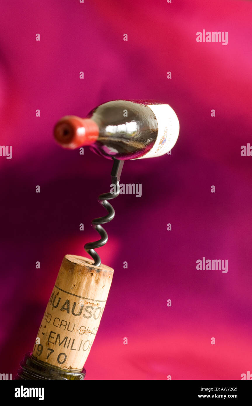 corkscrew shaped like a wine bottle opening a cork in a wine bottle on ...