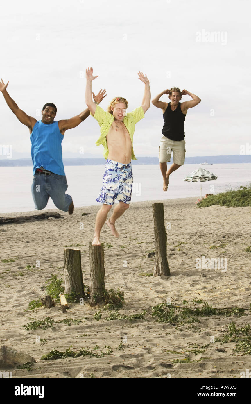 Men leaping off tree stumps Stock Photo - Alamy