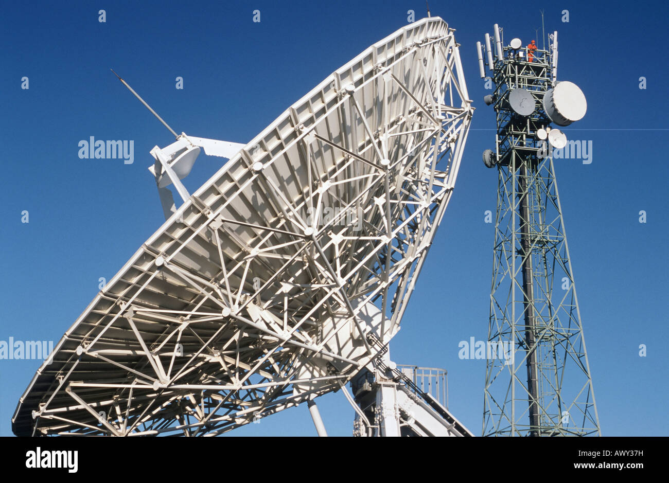 Telecommunications satellite dish and communications towers Stock Photo ...