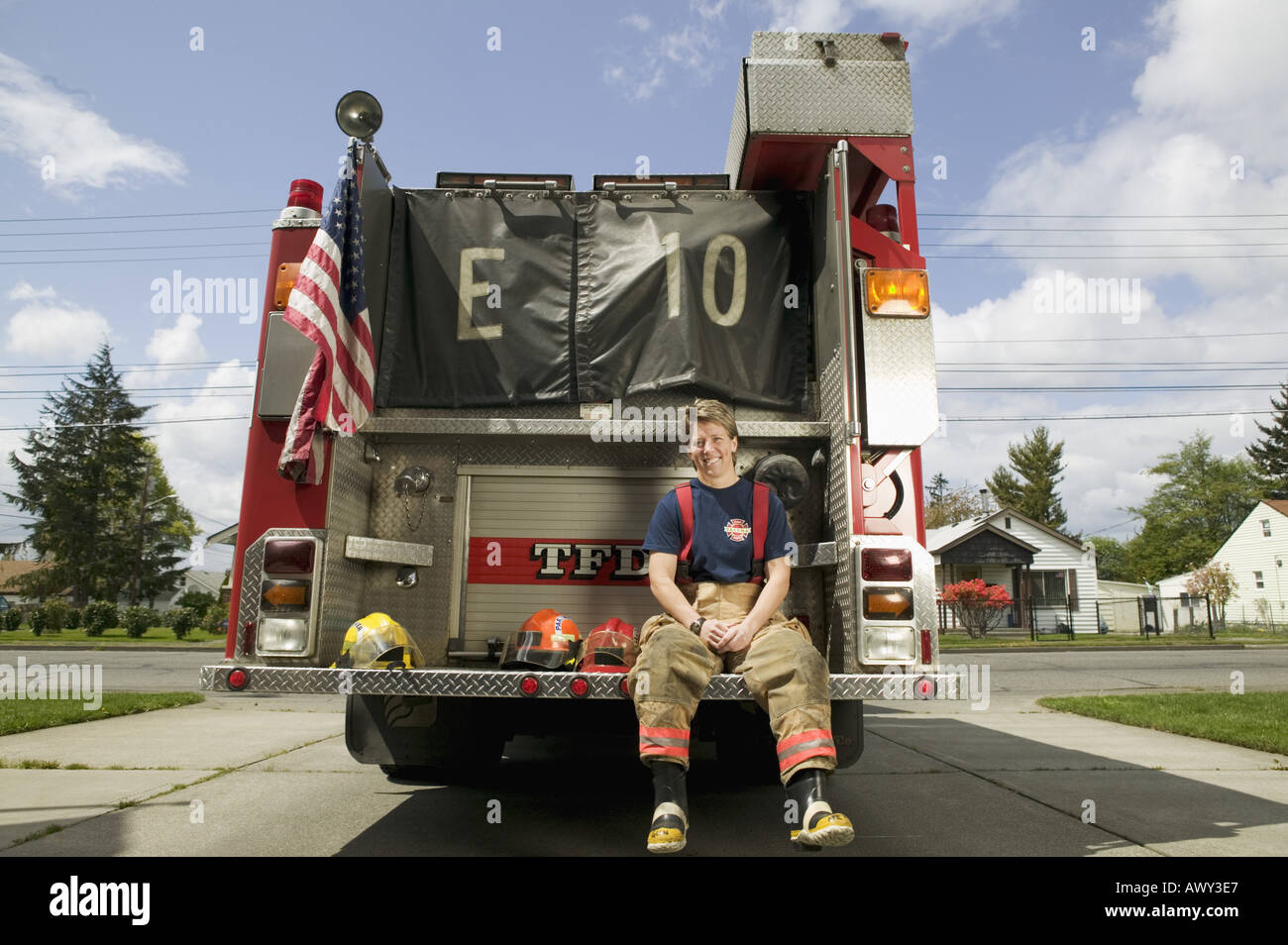 Female firefighter sitting on a fire truck Stock Photo - Alamy
