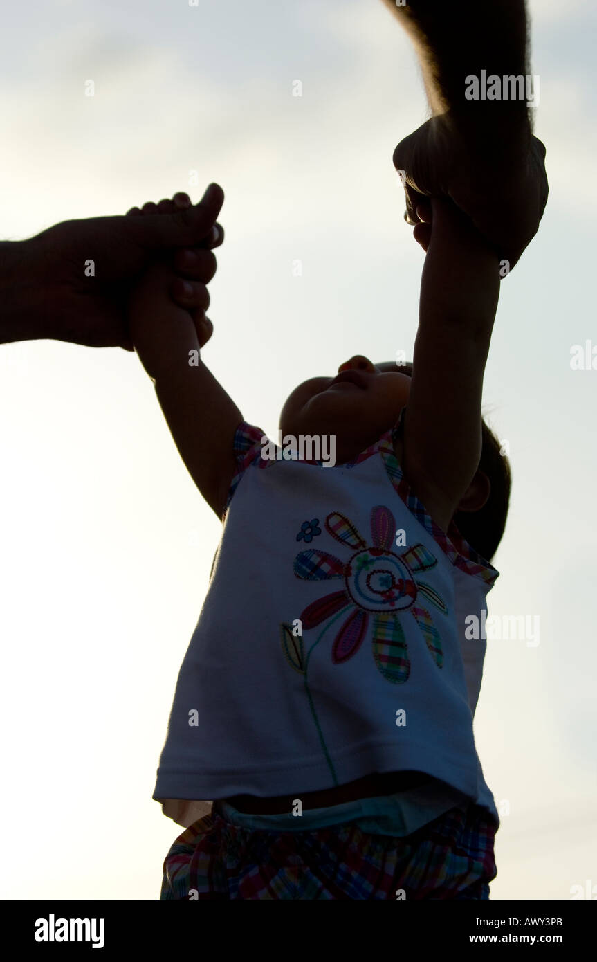 Baby girl being held Stock Photo - Alamy