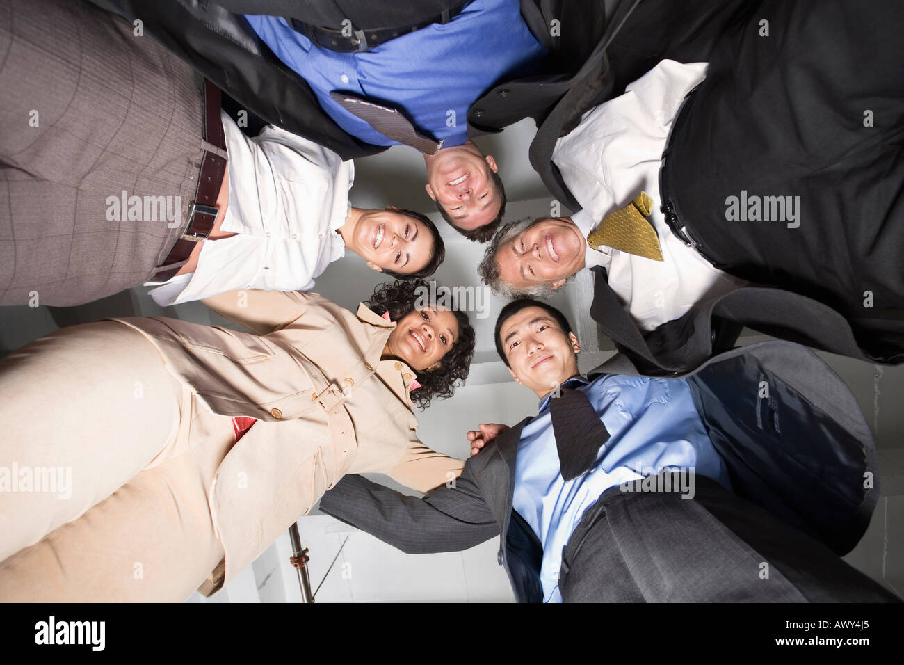 Group Portrait of Business People in Huddle Stock Photo - Alamy