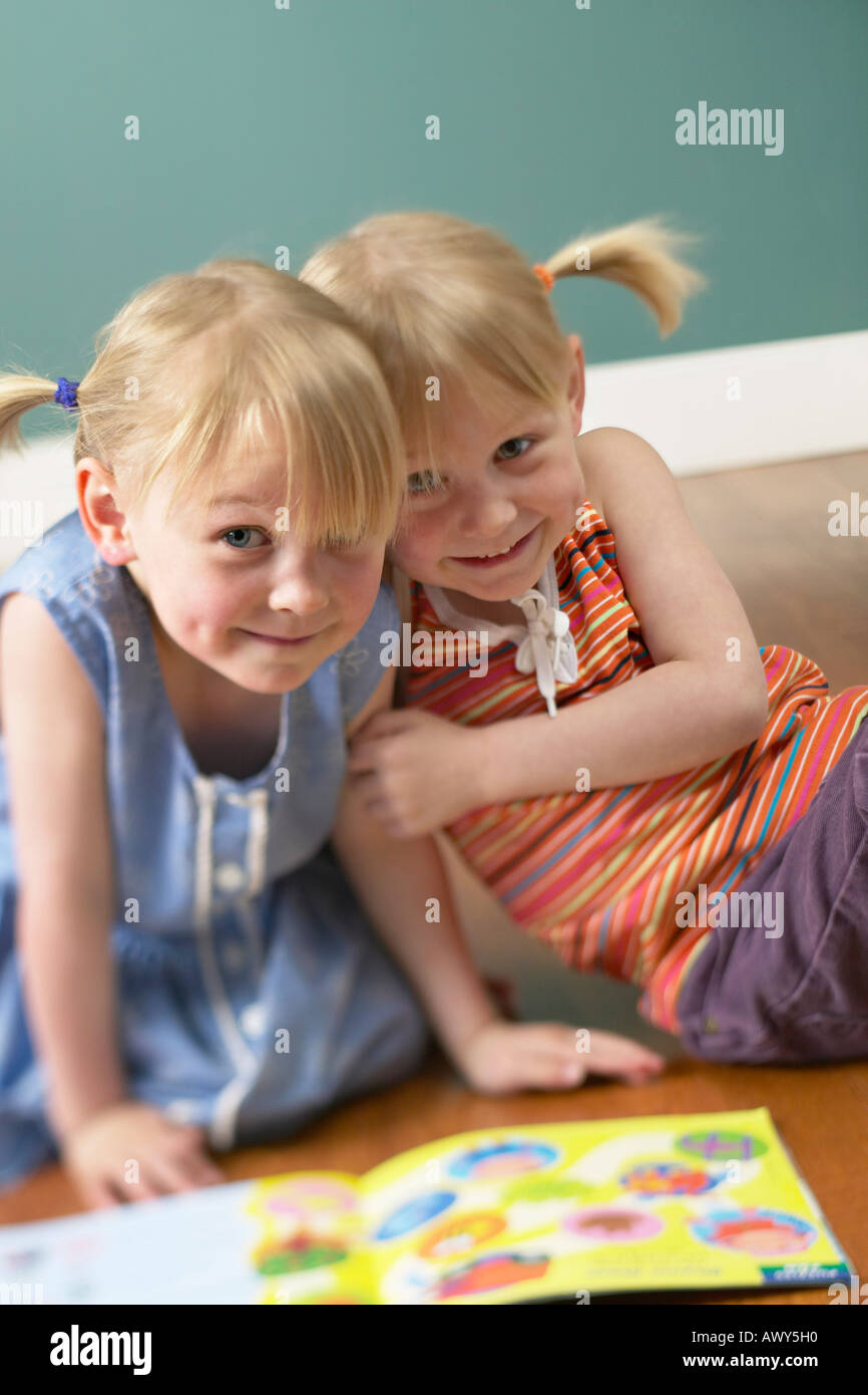 Twin Sisters Reading Book Stock Photo - Alamy