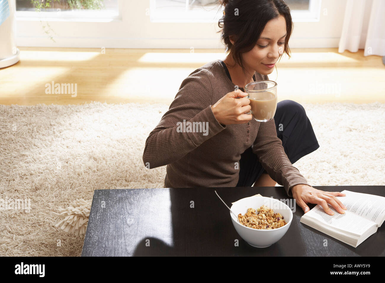Woman Reading During Breakfast Stock Photo - Alamy