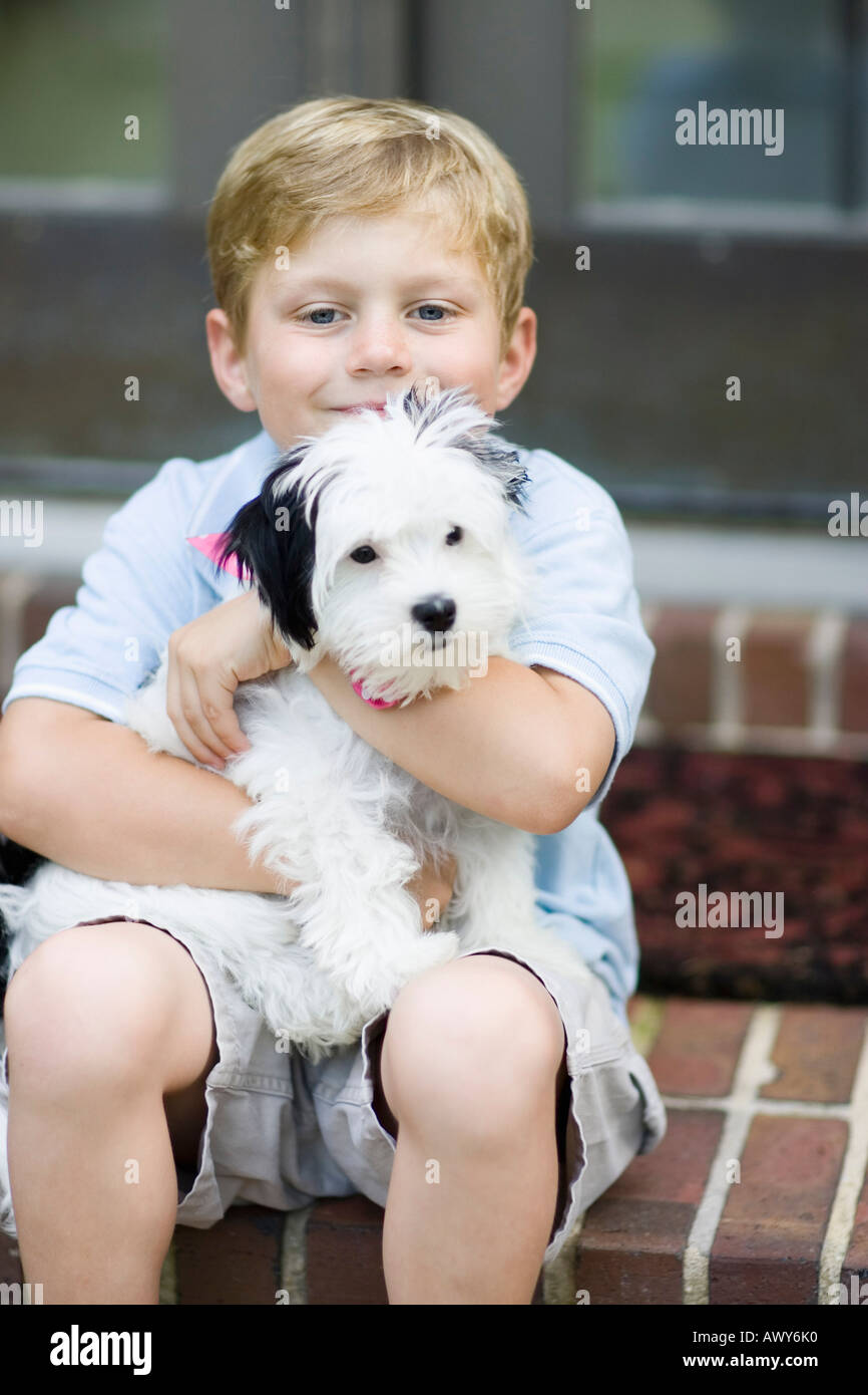 Portrait of Boy Holding Dog Stock Photo - Alamy