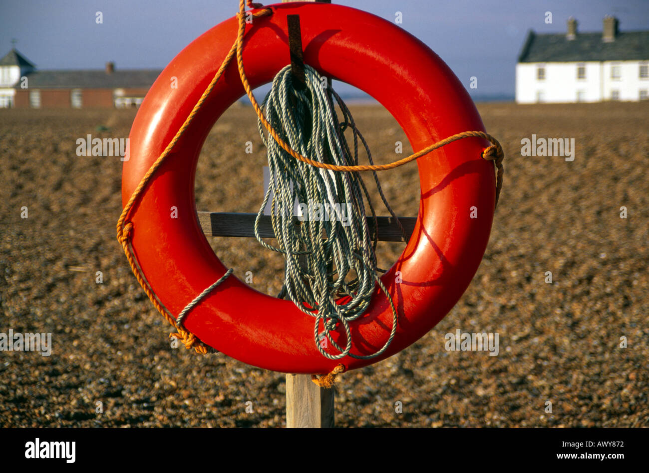 Red life belt on Shingle Street beach Suffolk England Stock Photo - Alamy