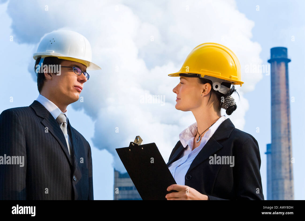 Young male and female managers working together in an industrial ...