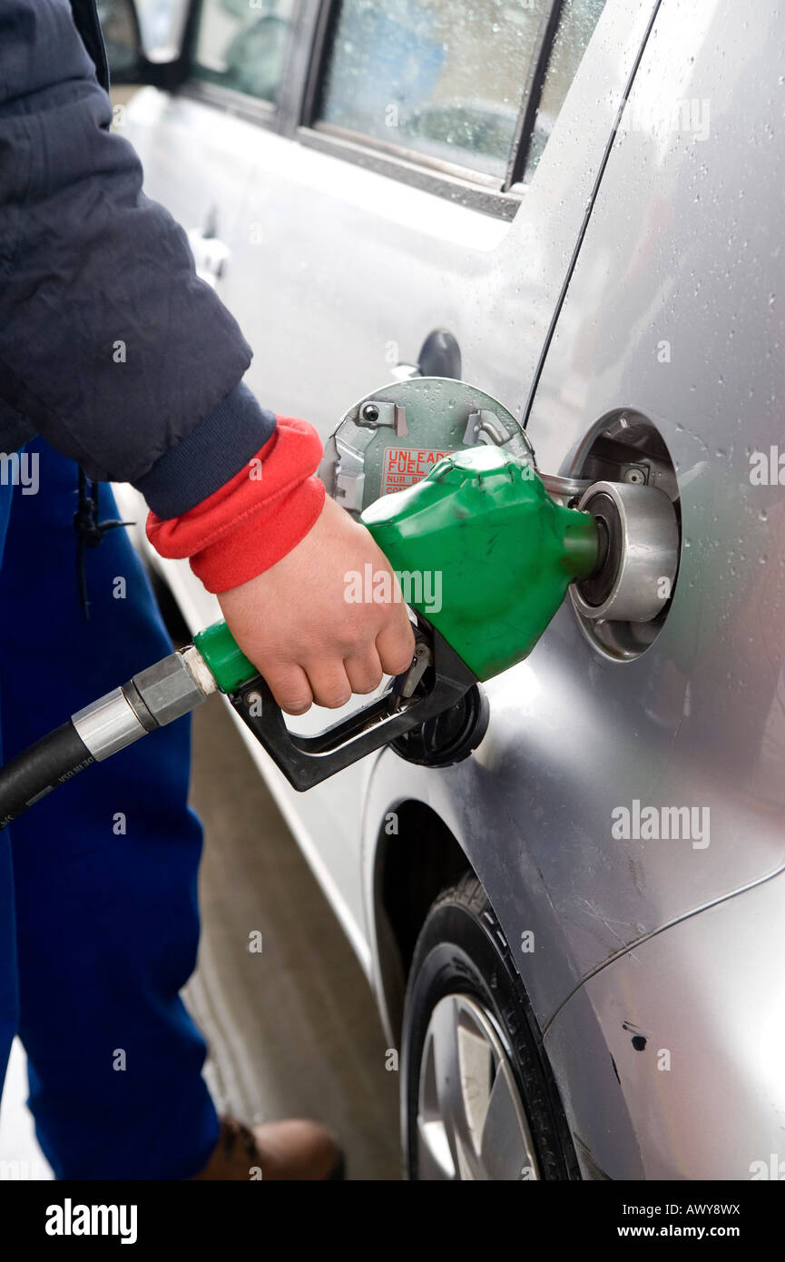 A hand of a man filling up unleaded petrol at a petrol station Stock ...