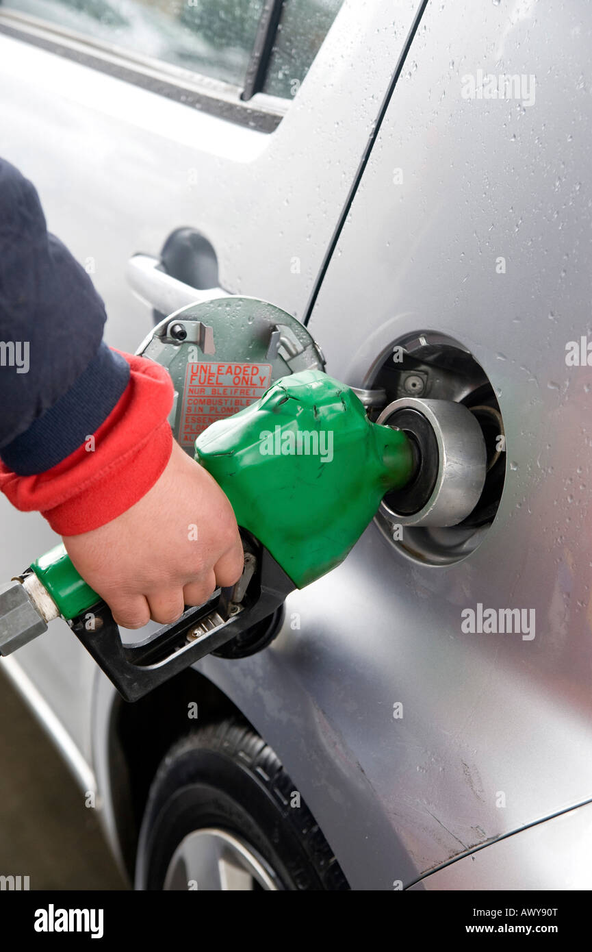 A hand of a man filling up unleaded petrol at a petrol station Stock ...