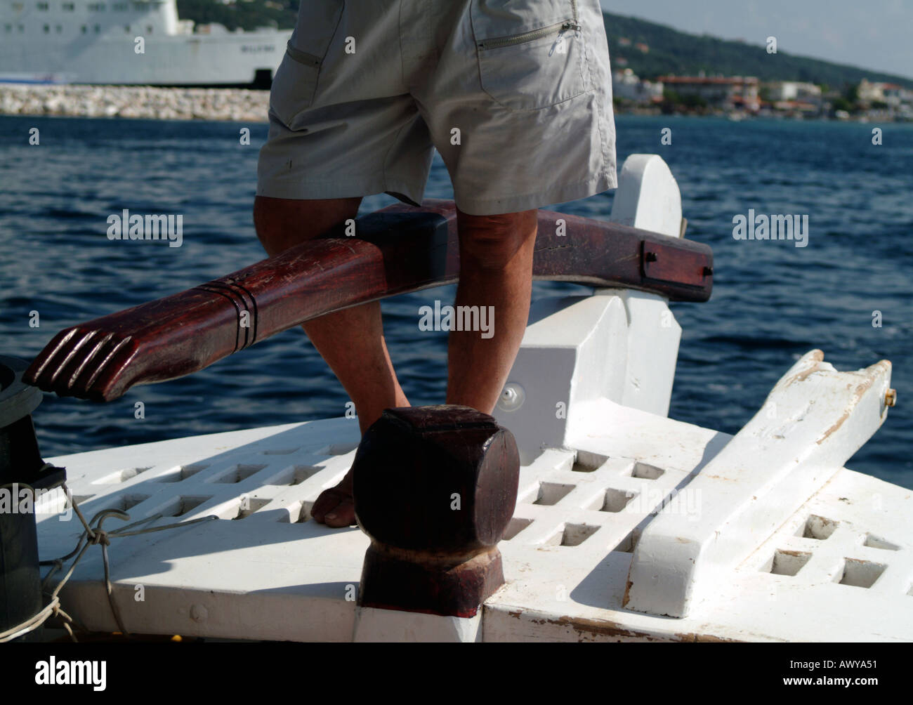 man steering boat with legs Stock Photo - Alamy