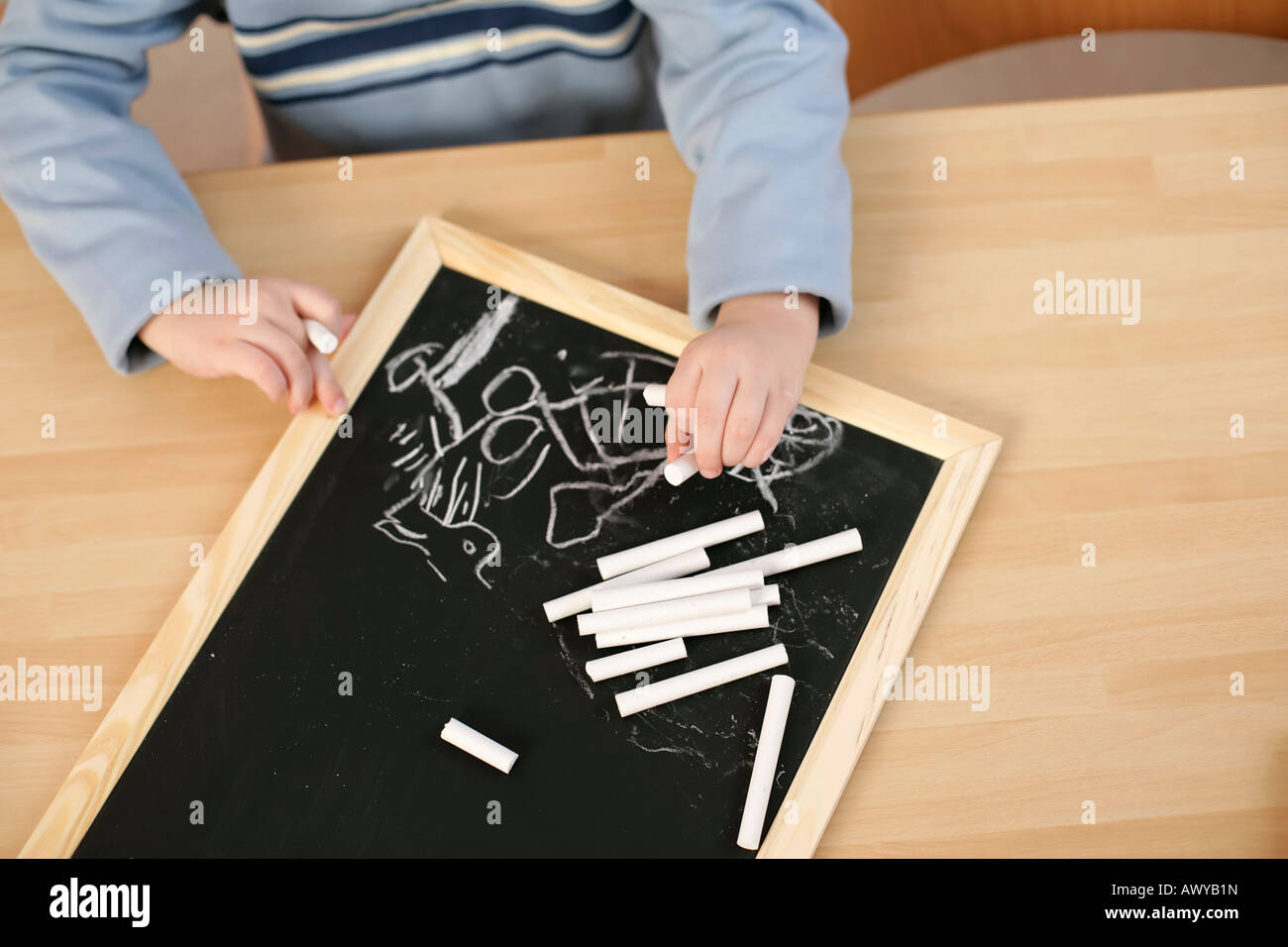Child drawing on a chalkboard Stock Photo - Alamy