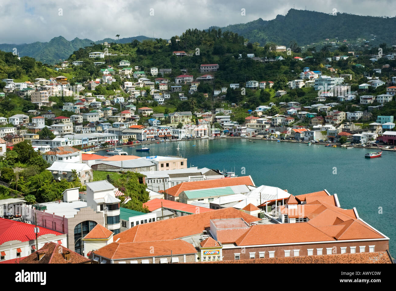 Boats moored in the blue inland harbour of St George's surrounded by ...