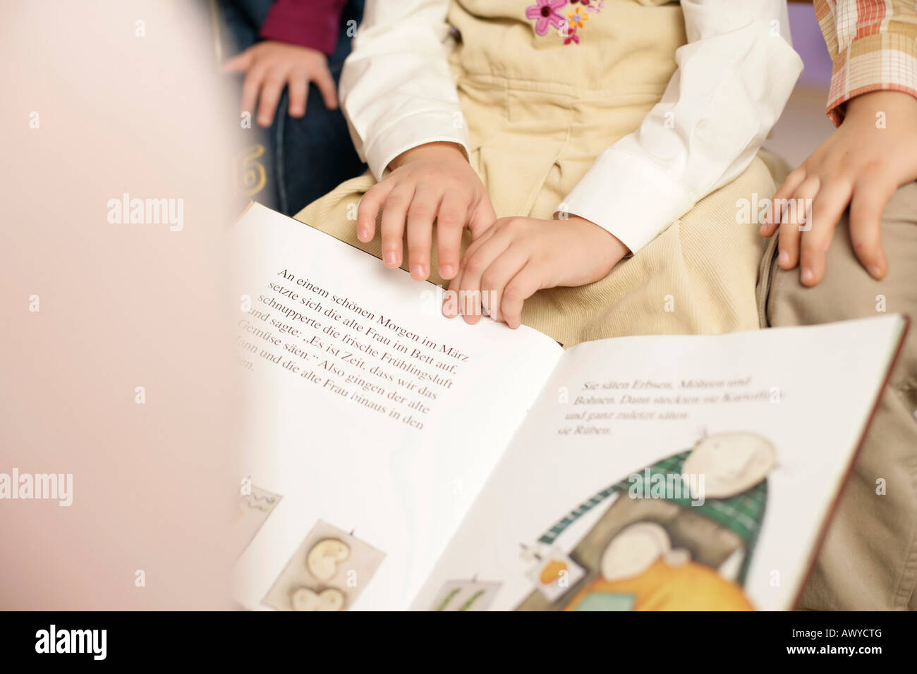 Woman reading to children, focus on storybook Stock Photo - Alamy