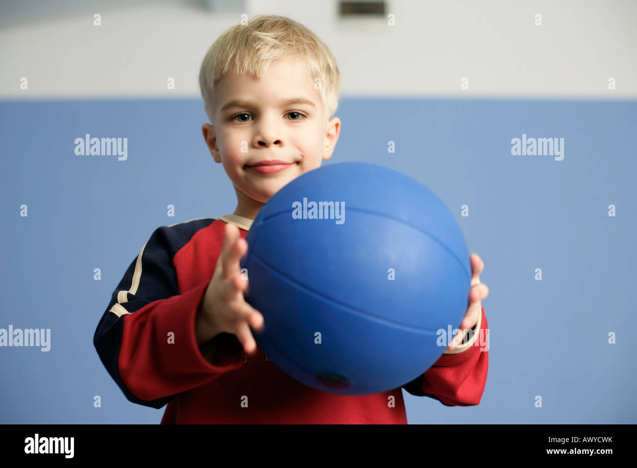 Little boy holding a blue ball Stock Photo - Alamy