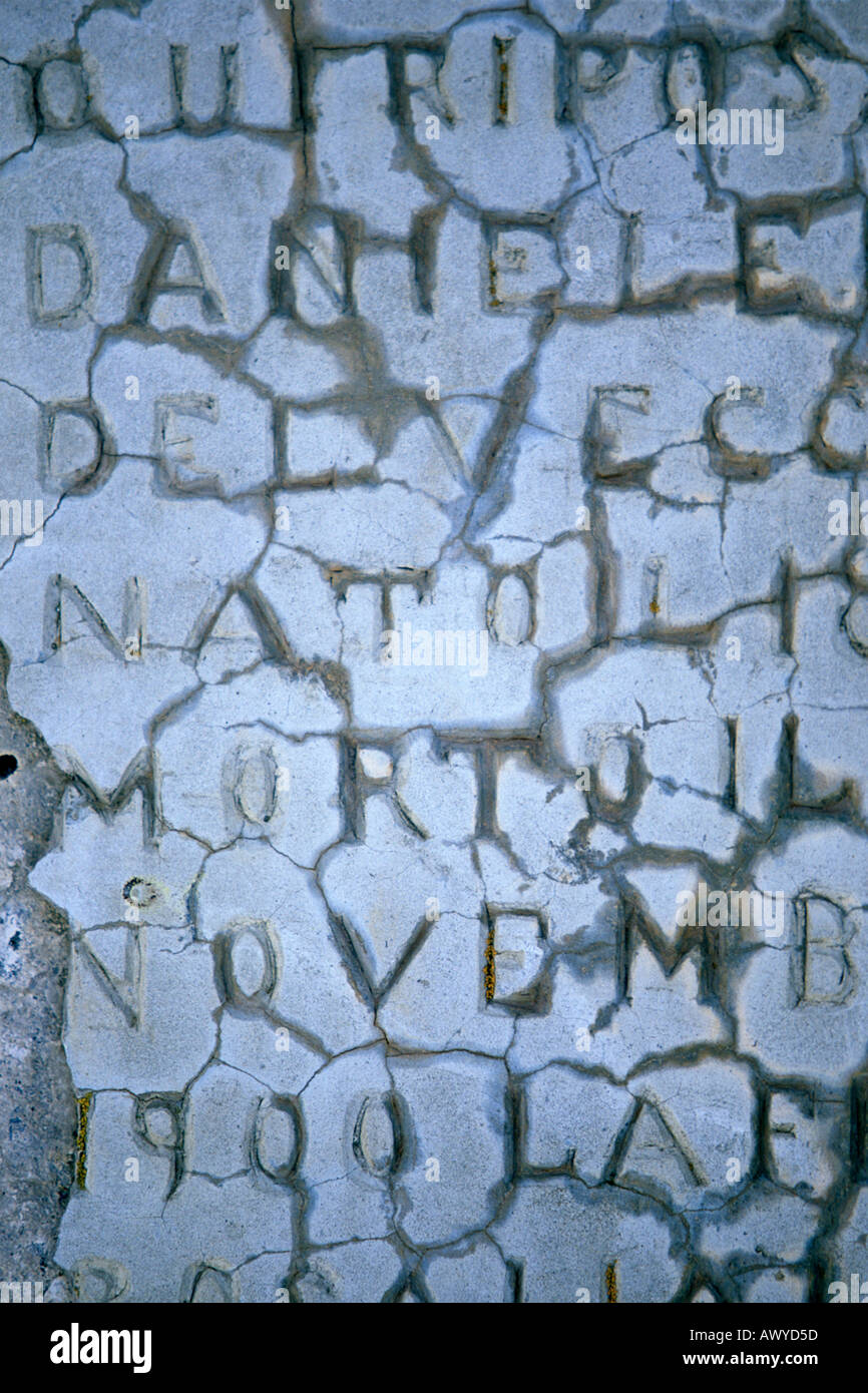 The cracked, weathered front of an old tombstone in Glenwood Springs ...